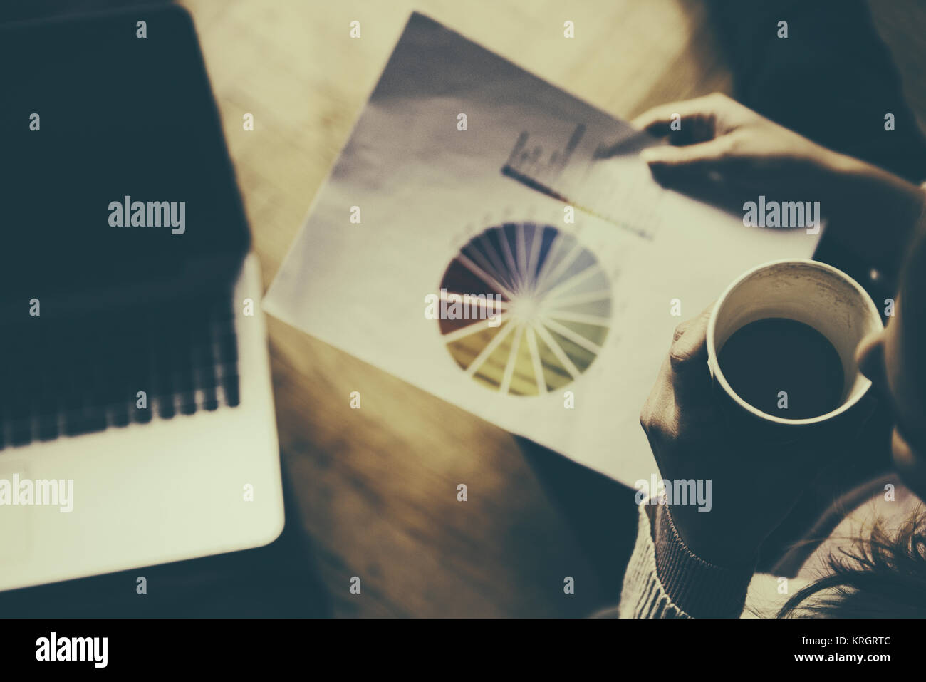 Team viewing business reports Stock Photo - Alamy