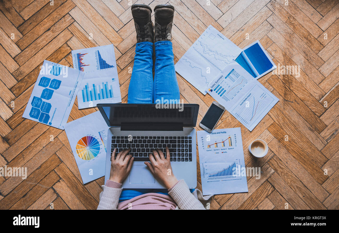 Relaxing work at home: concept with a girl sitting on the floor with ...