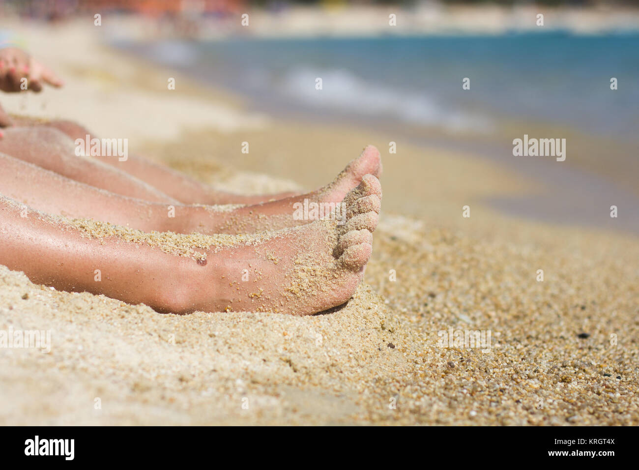 Woman Legs on the Beach Stock Photo - Alamy