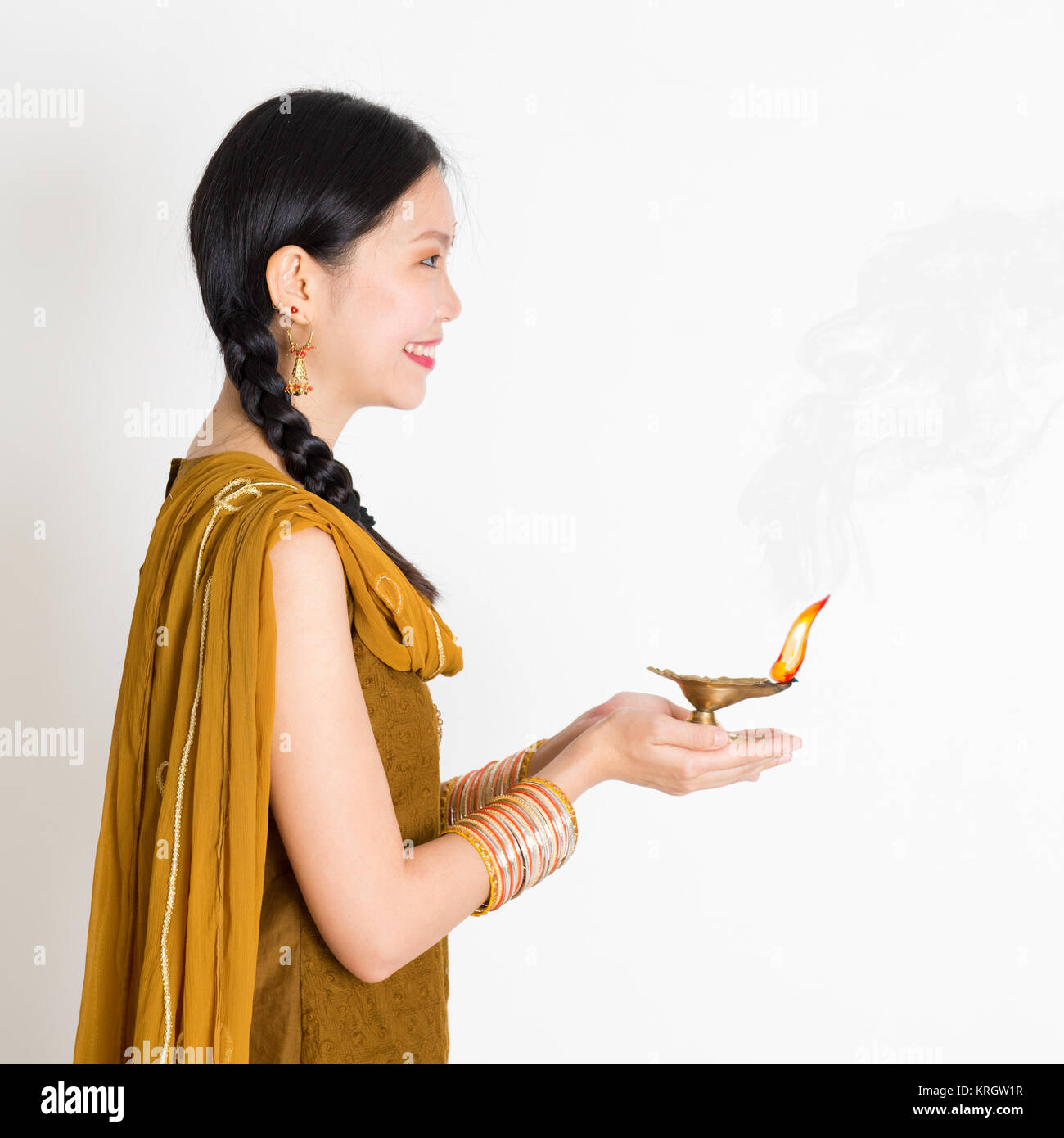 Lady holding diya hi-res stock photography and images - Alamy