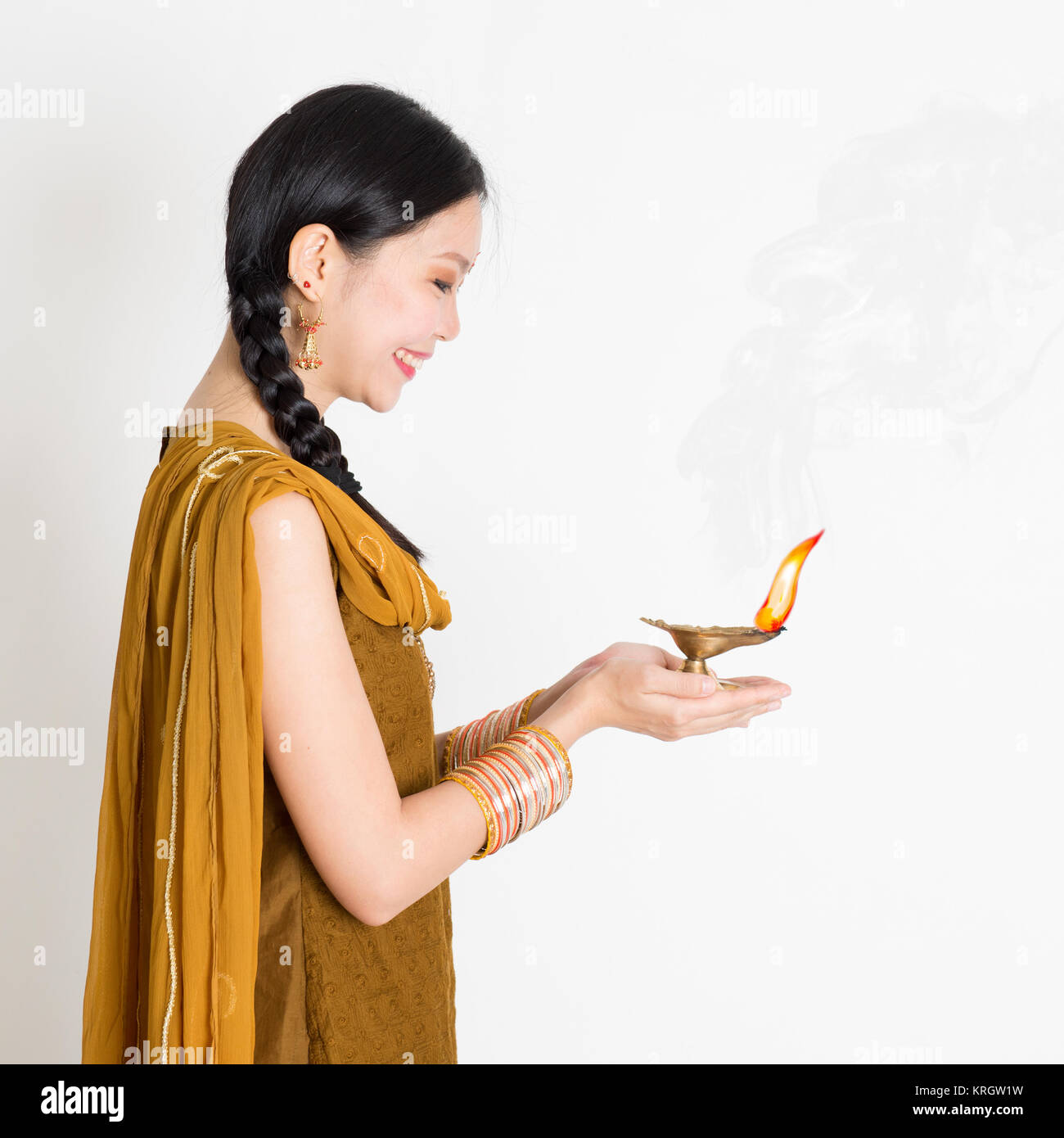 Girl holding diya light Stock Photo - Alamy