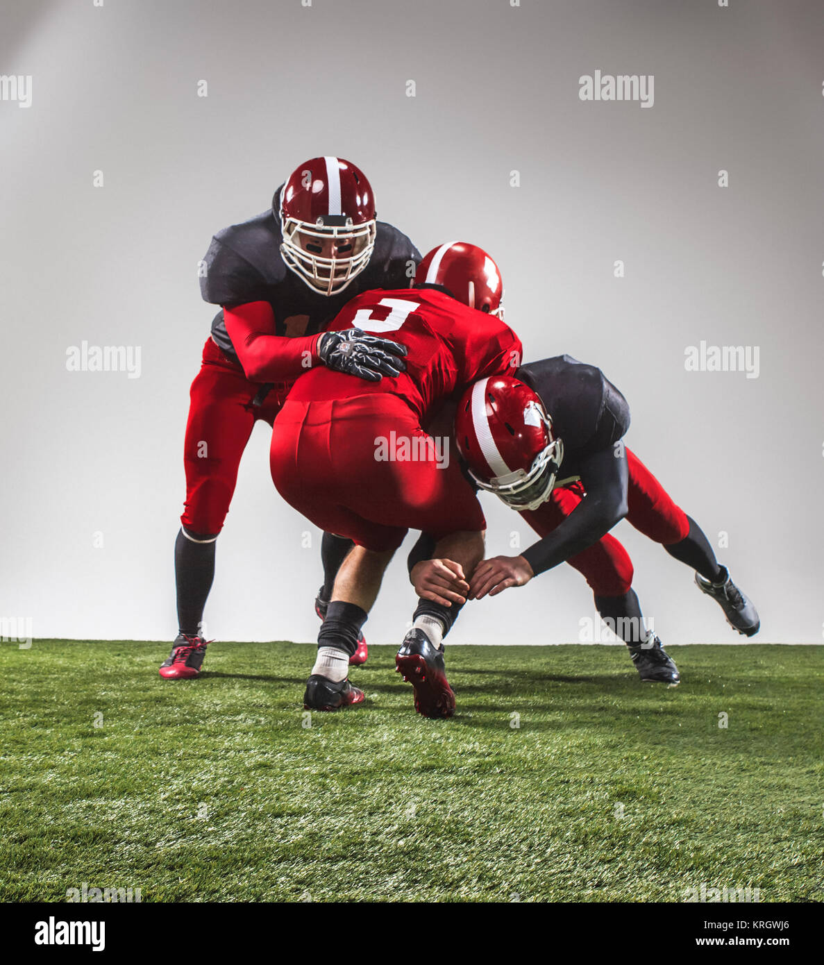The three american football players in action Stock Photo - Alamy