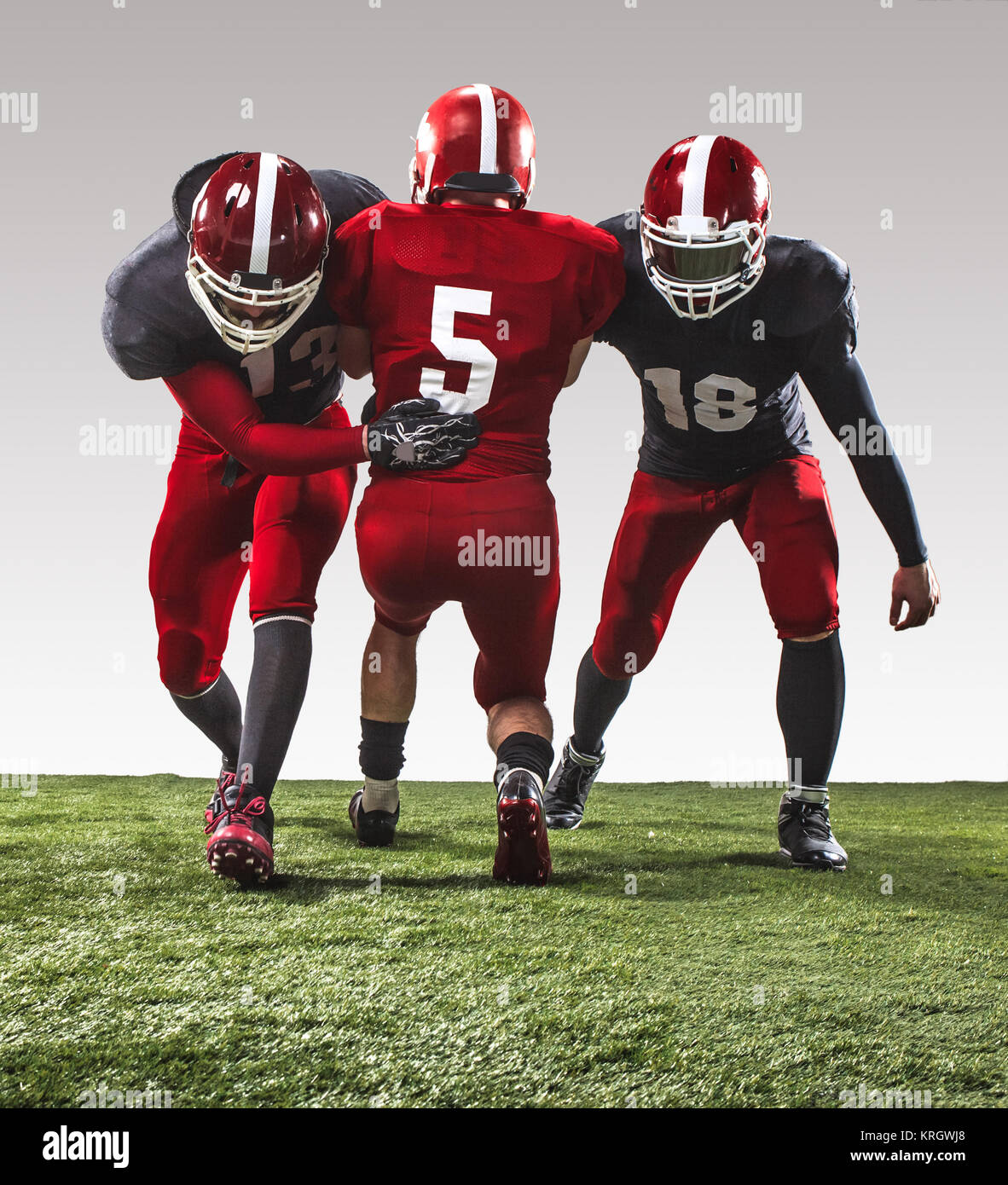 The three american football players in action Stock Photo - Alamy