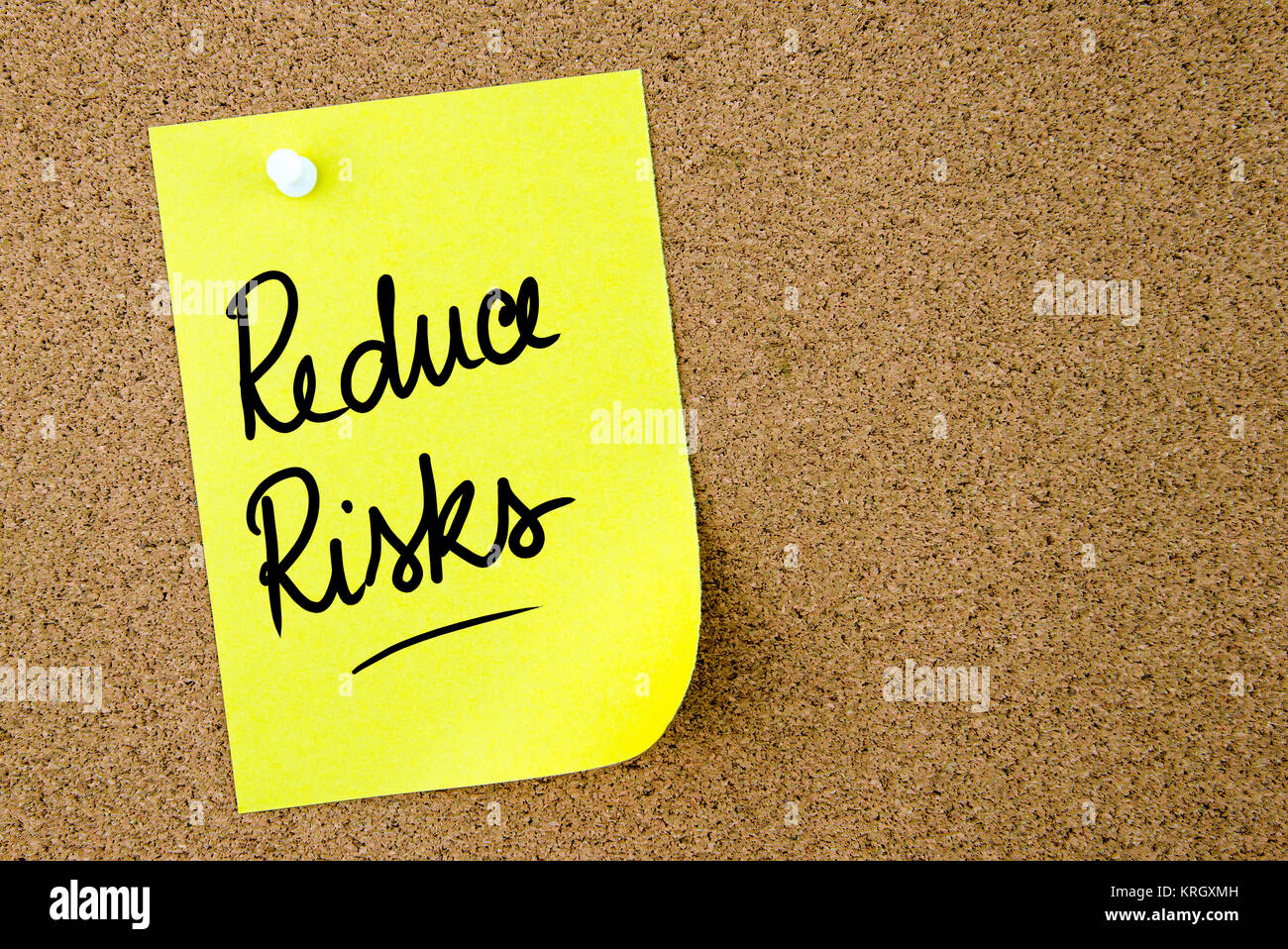 Reduce Risks text written on yellow paper note Stock Photo - Alamy