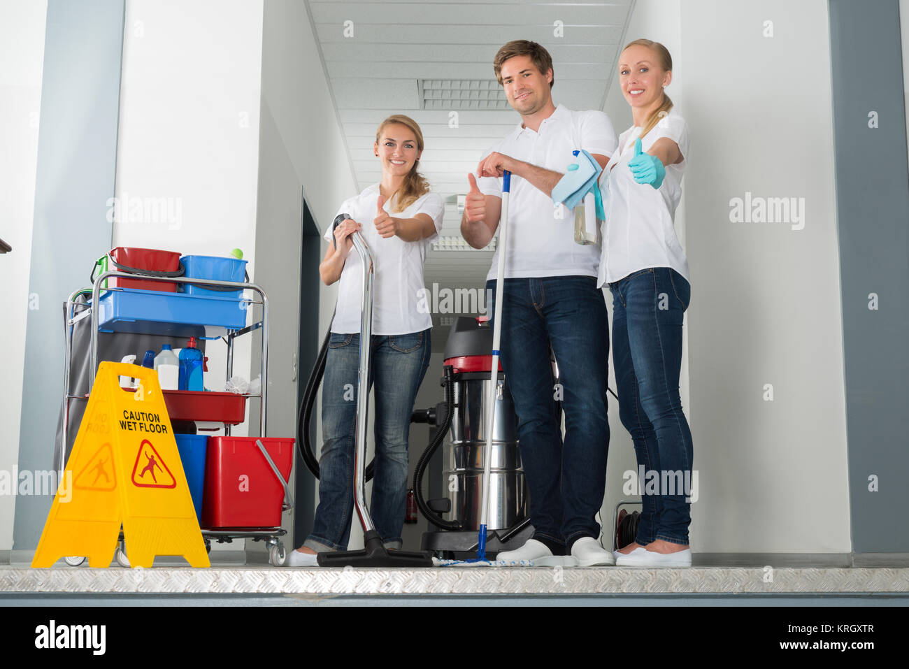 Group Of Happy Young Janitor Showing Thumbs Up Stock Photo - Alamy