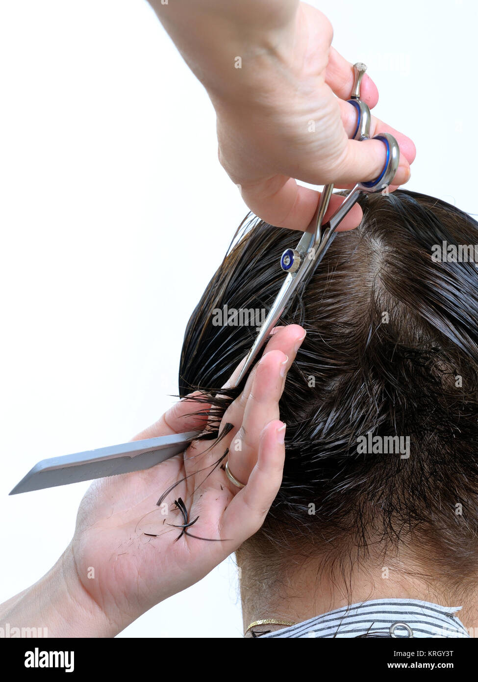 Hairdresser who performs a fashionable cut on the hair of a woman of ...