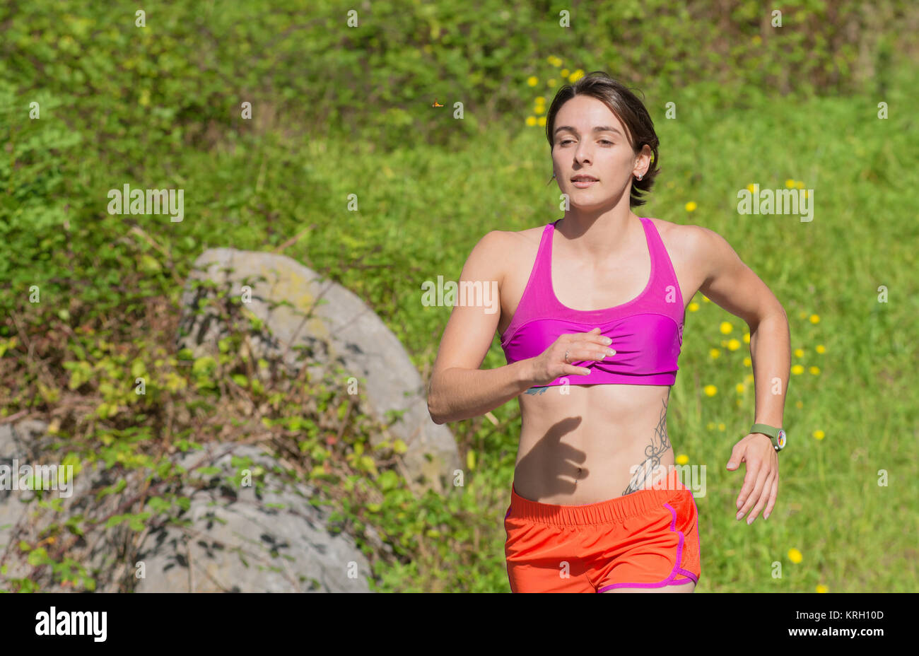Beautiful athletic woman running in countryside Stock Photo - Alamy