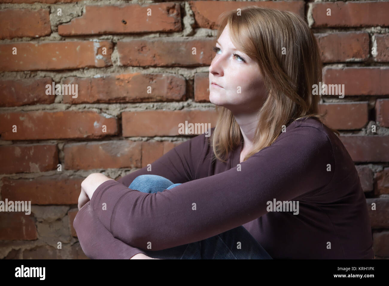 Side view of a saddly young woman Stock Photo - Alamy
