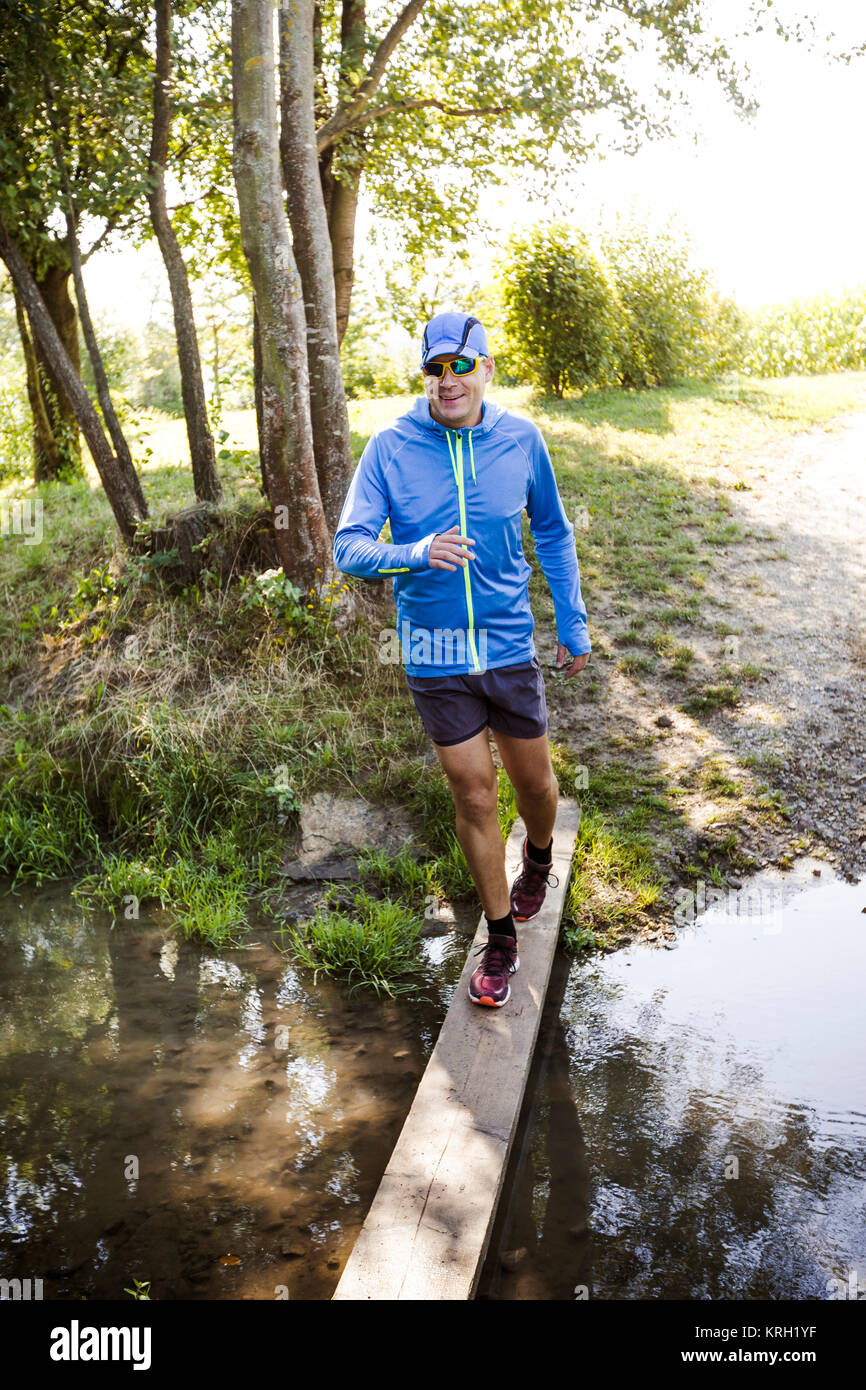 young man jogging at the woods Stock Photo - Alamy