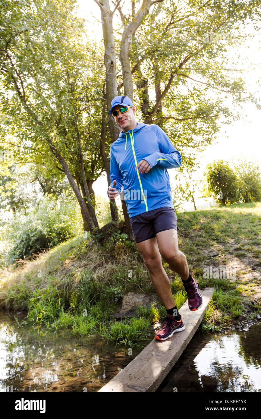 young man jogging at the woods Stock Photo - Alamy