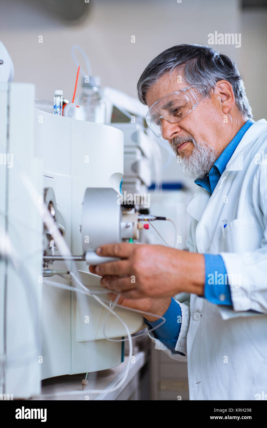 senior male researcher carrying out scientific research in a lab using ...
