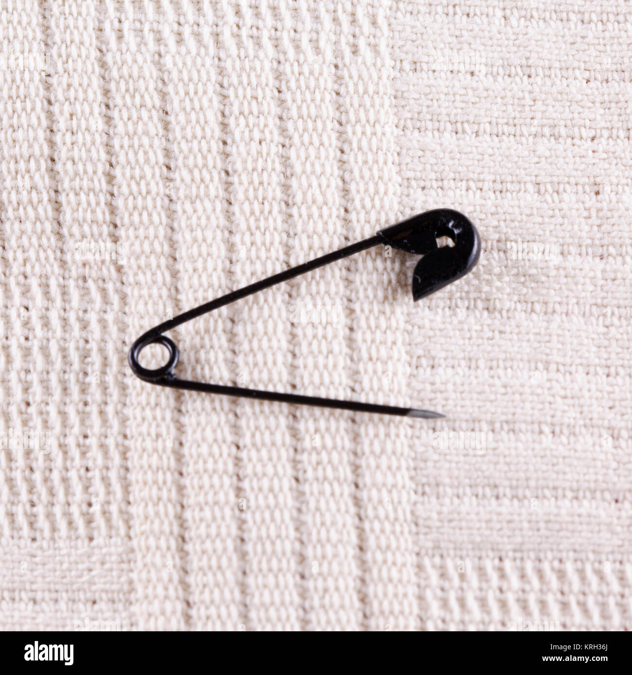 Safety pin over tissue background Stock Photo - Alamy