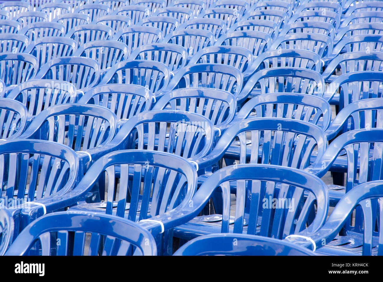 Many rows of blue pastic chairs Stock Photo - Alamy