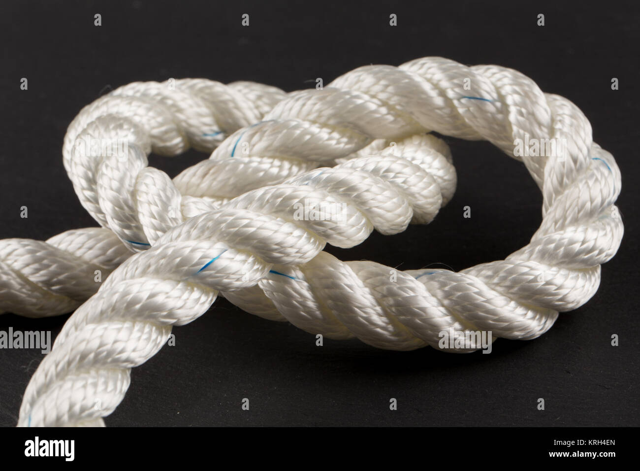 knot of rope on dark Stock Photo - Alamy