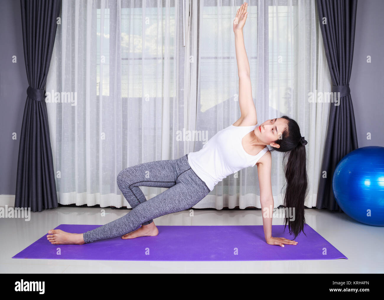 young woman doing yoga exercise isolated on a white background Stock ...