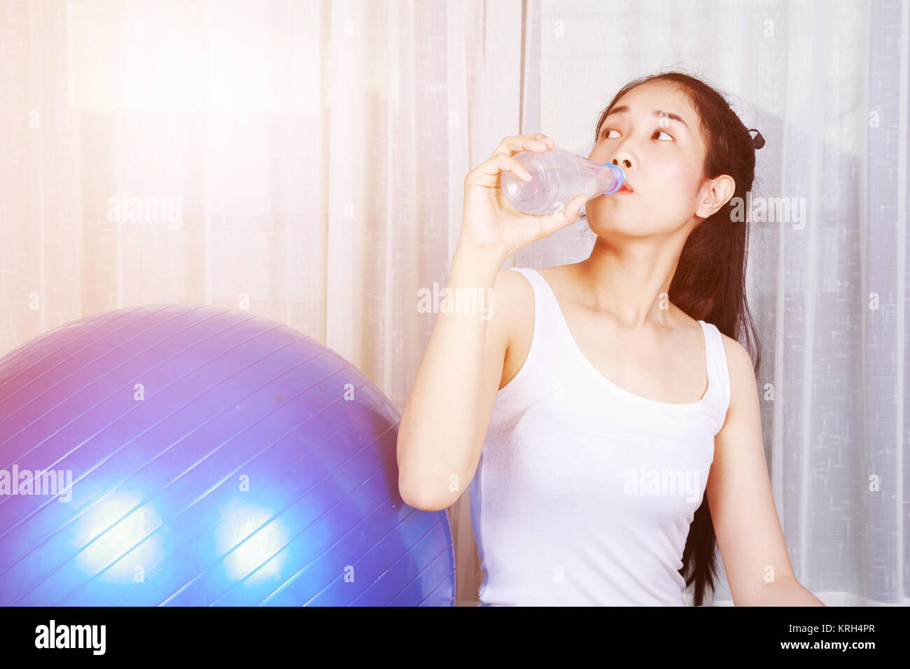 sport woman drinking water after exercise with fitness ball Stock Photo ...