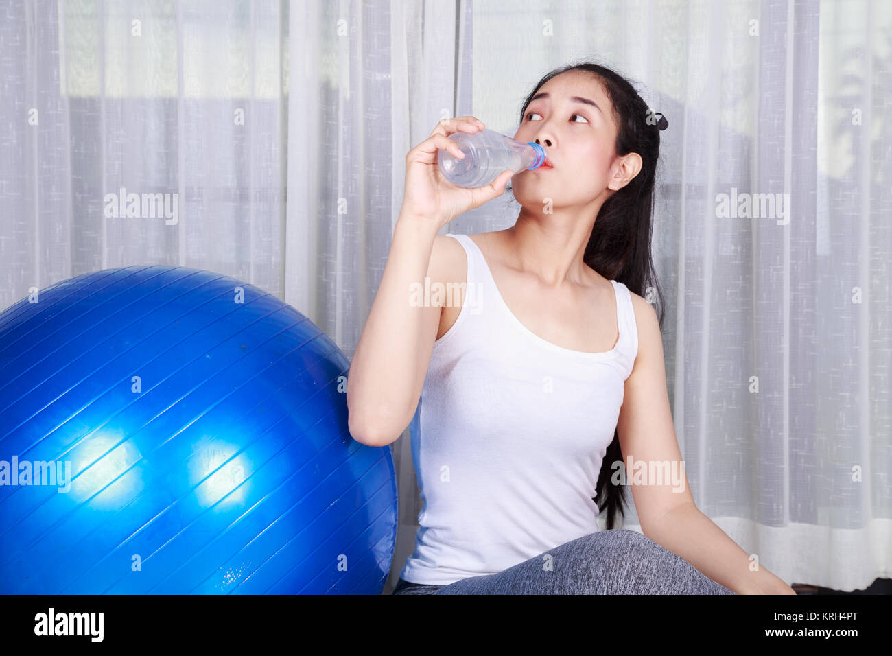 sport woman drinking water after exercise with fitness ball Stock Photo ...