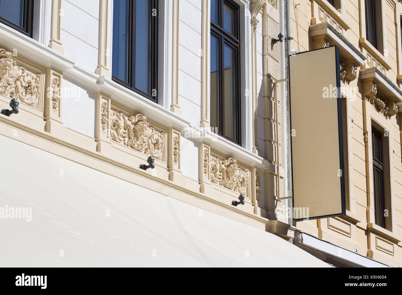 Vertical empty signboard on a building with classical architecture ...