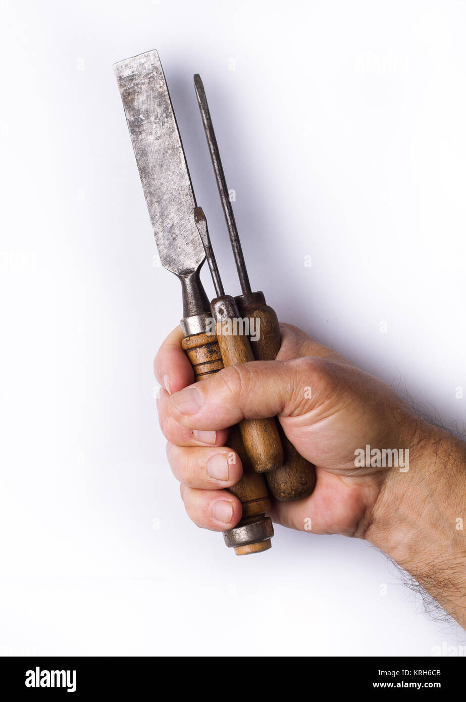 Strong hand holding tools with wooden handles on white background Stock ...