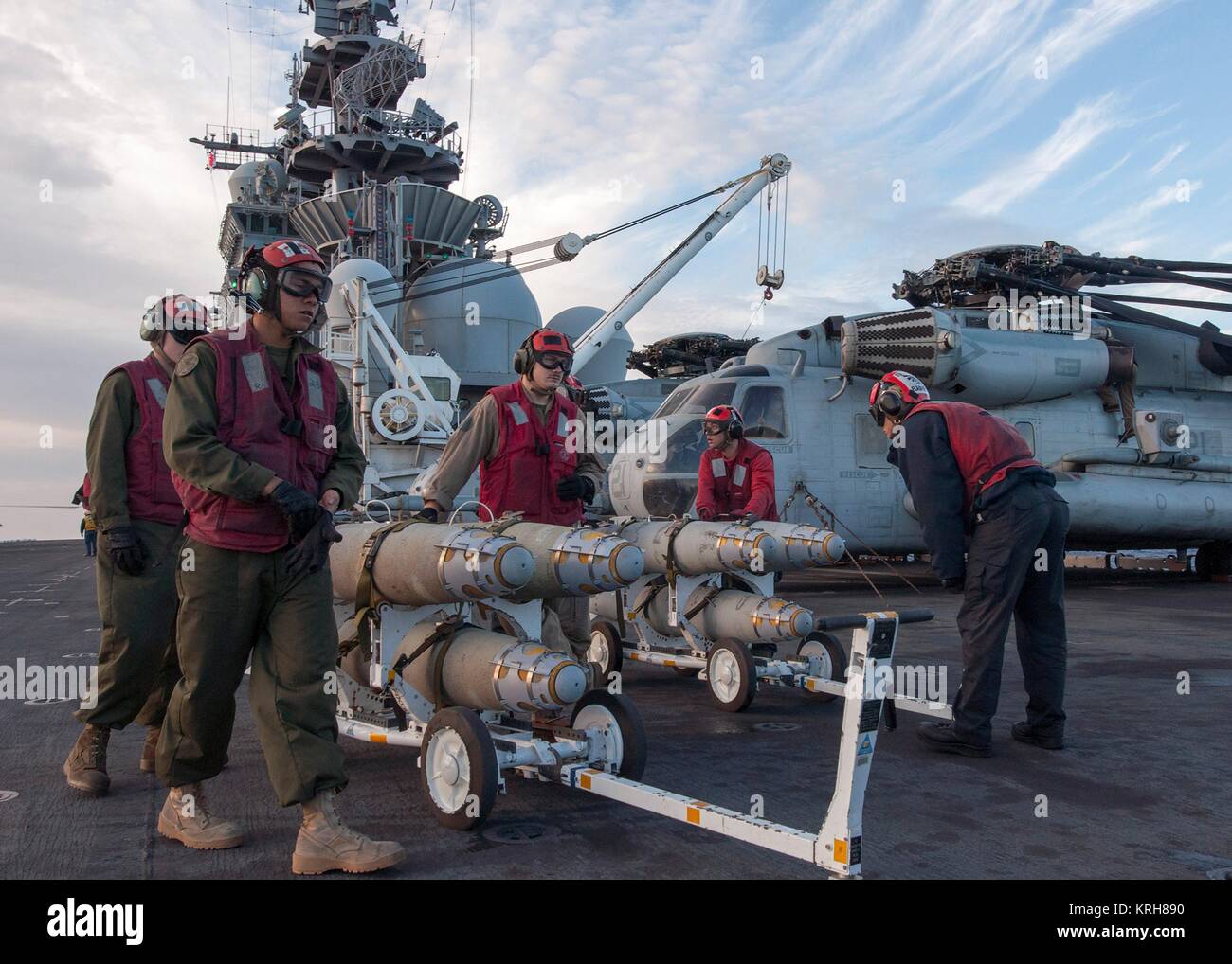 U.S. Marines load ordinances onto a McDonnell Douglas AV-8B Harrier ...