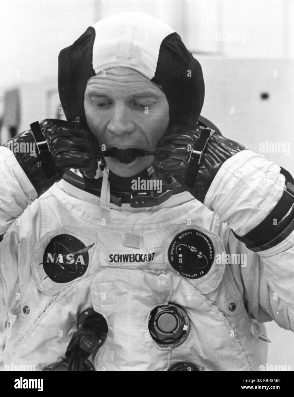 Apollo 9 Lunar Module Pilot Russell L. Schweickart adjusts microphones ...