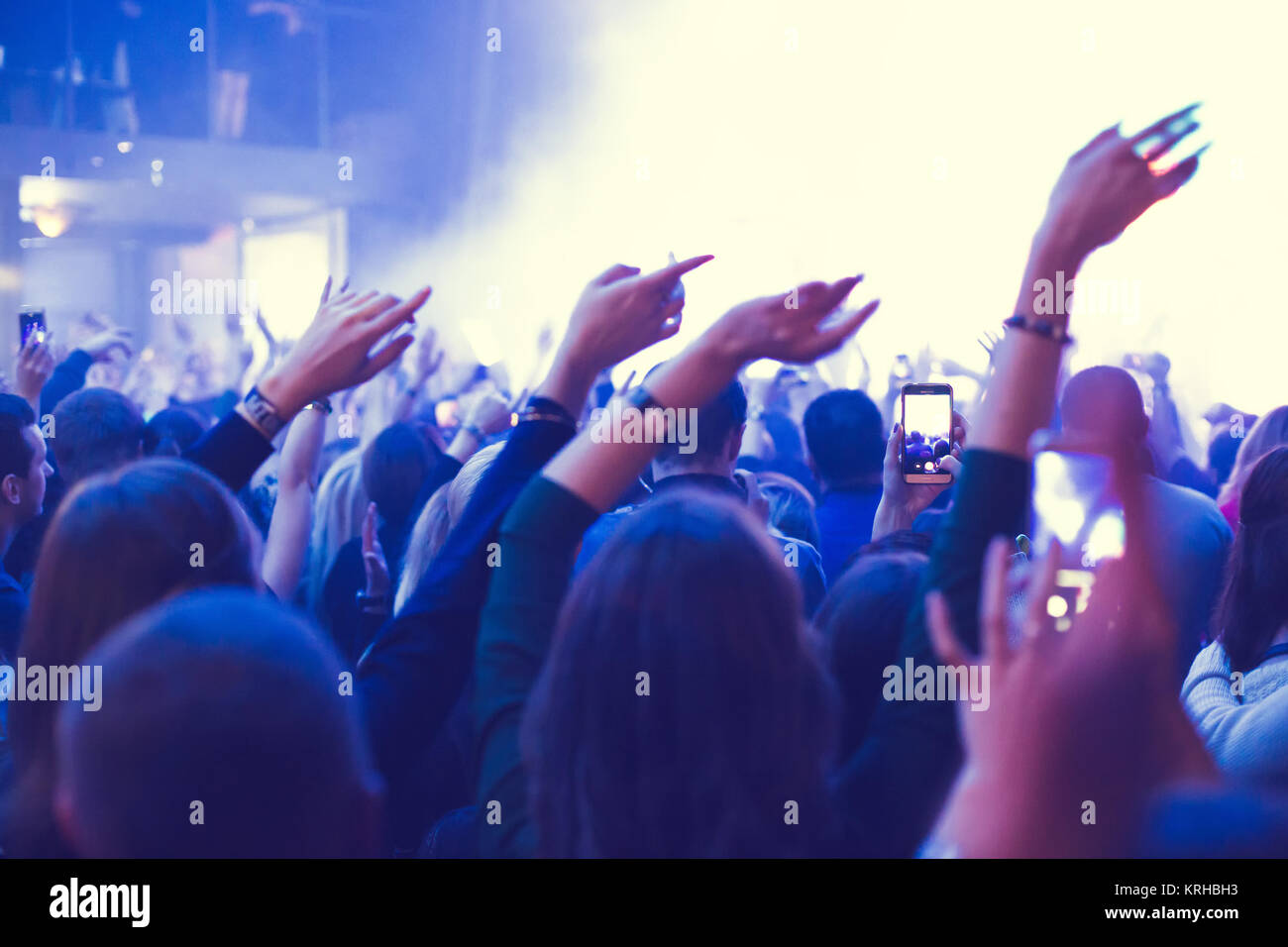 The audience watching the concert on stage Stock Photo - Alamy