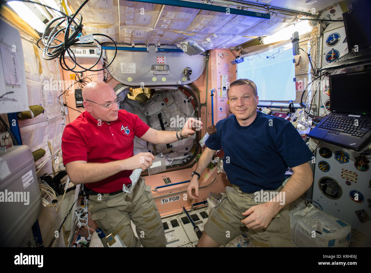 ISS-43 Scott Kelly and Terry Virts share a snack the Unity module Stock ...