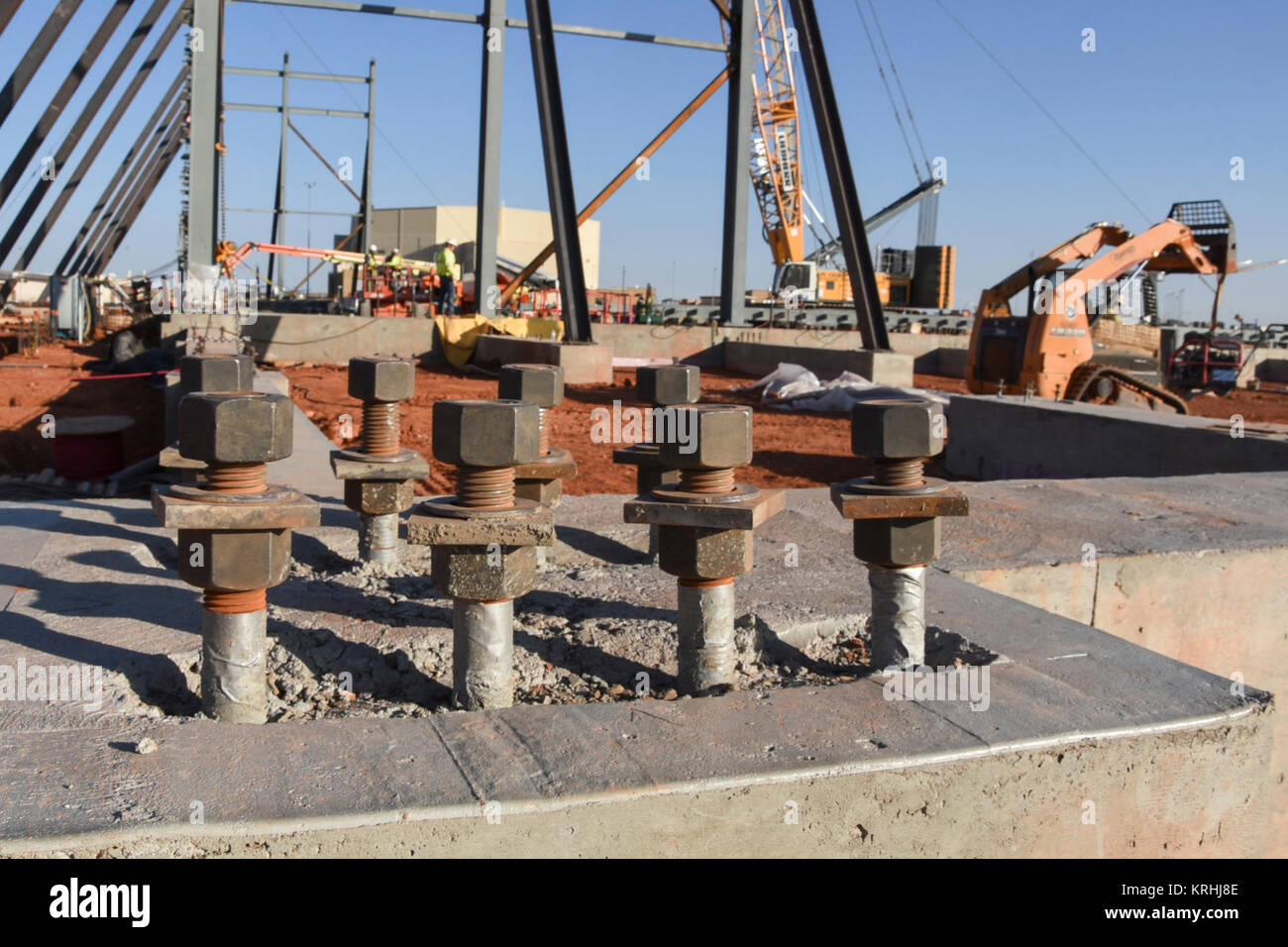Massive steel rods secured in concrete footings are capped with large ...