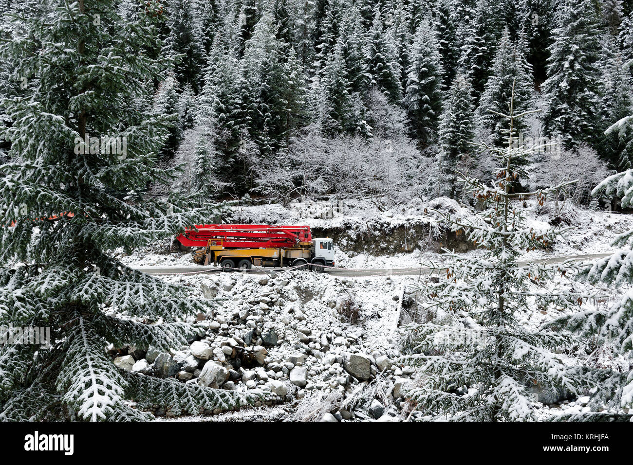 Difficult working conditions - a truck with a crane rides a mountain ...