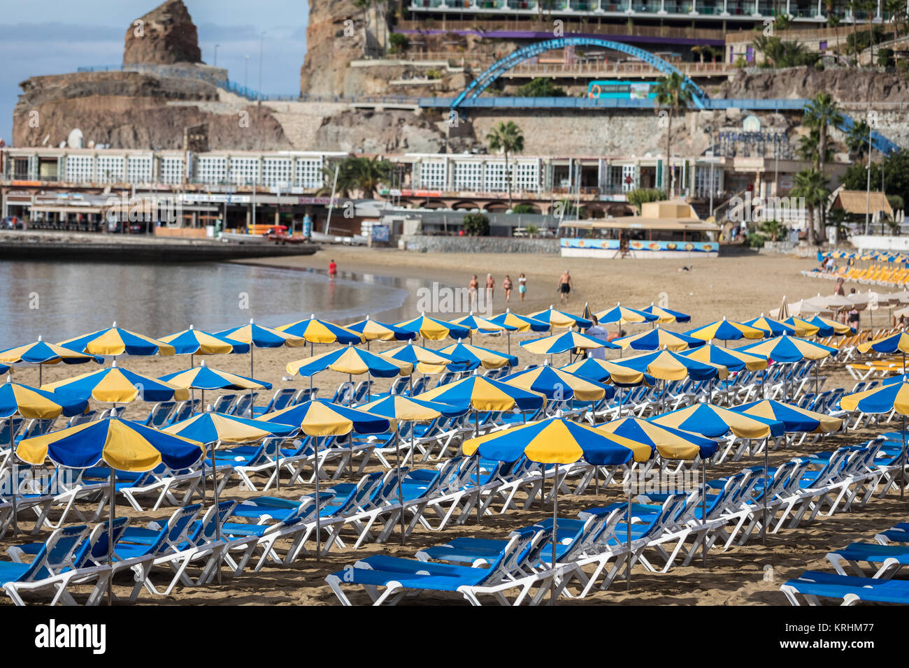 Rows of blue sunbeds with blue and yellow parasols at the beach Playa ...