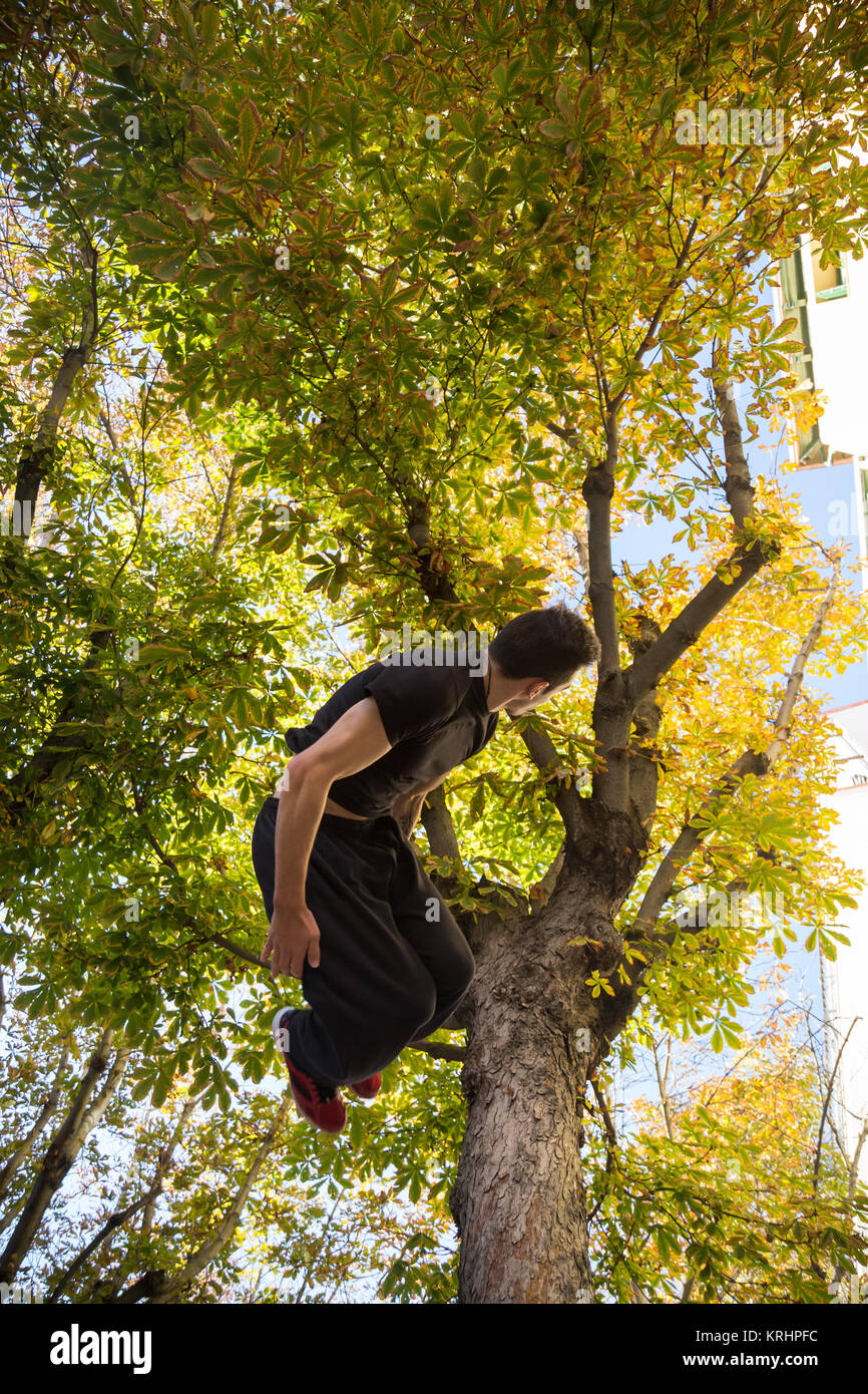 Young man doing a side flip or somersault while practicing parkour on ...