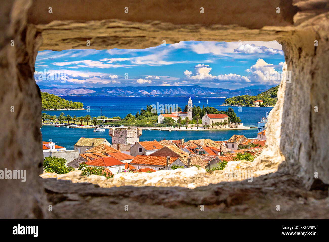 Vis bay waterfront view through stone window Stock Photo - Alamy