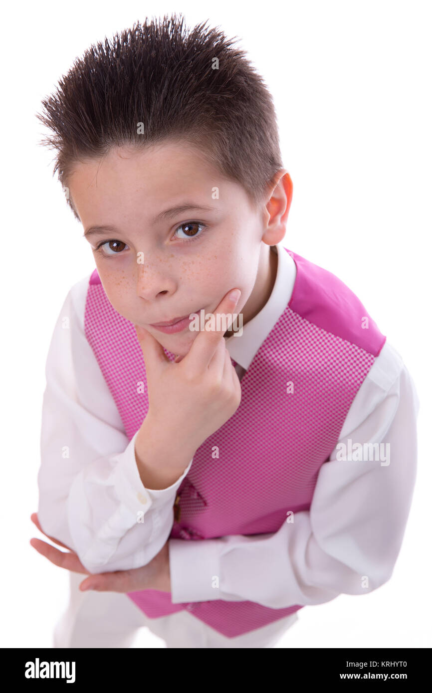 Young boy holding his chin in his First Holy Communion looking from ...