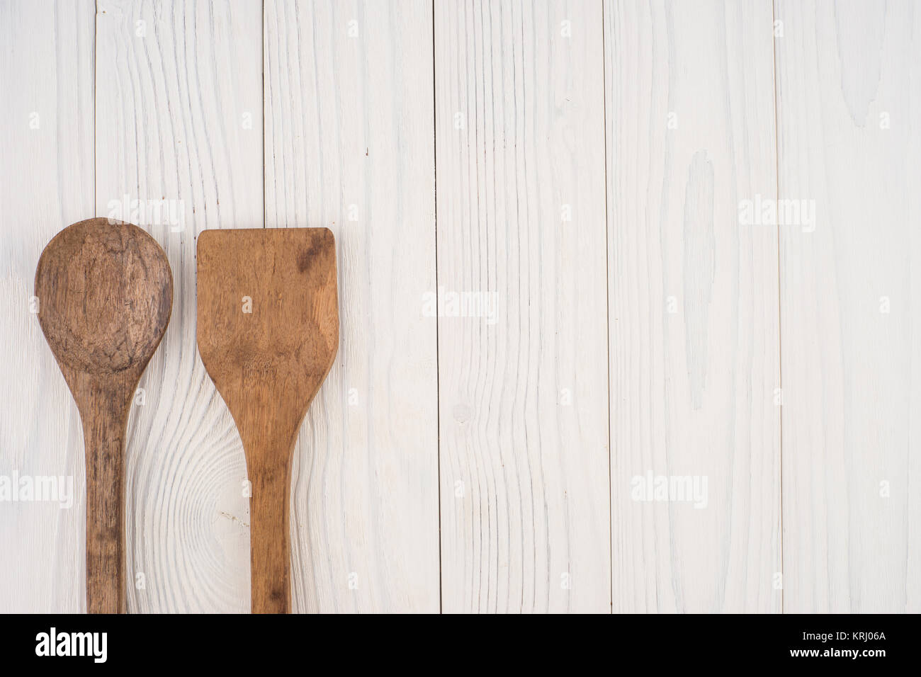 Wooden spoon and spatula on old white table Stock Photo - Alamy