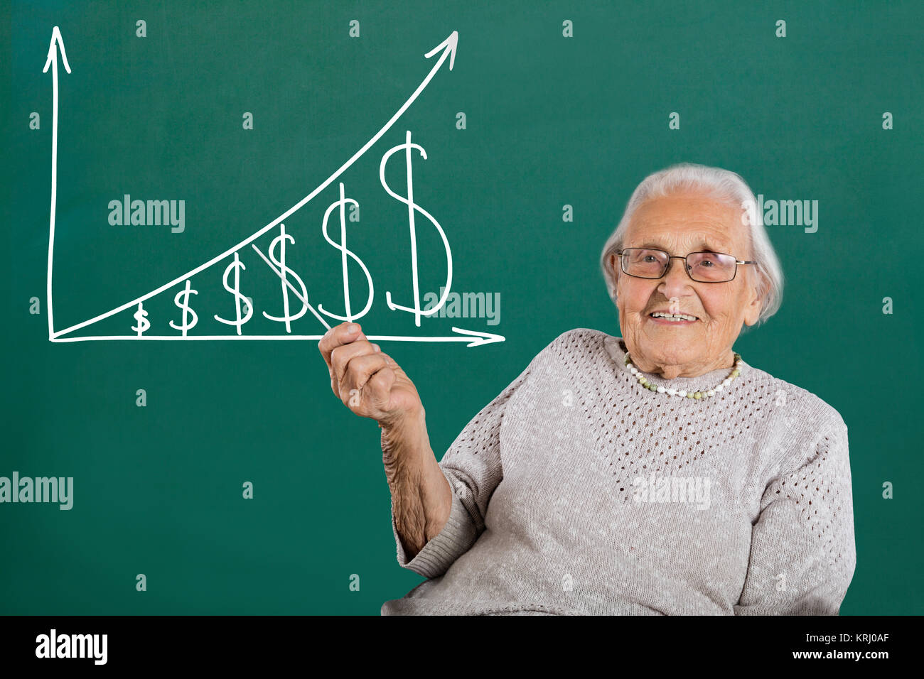 Female Teacher Showing Graph On Blackboard Stock Photo - Alamy