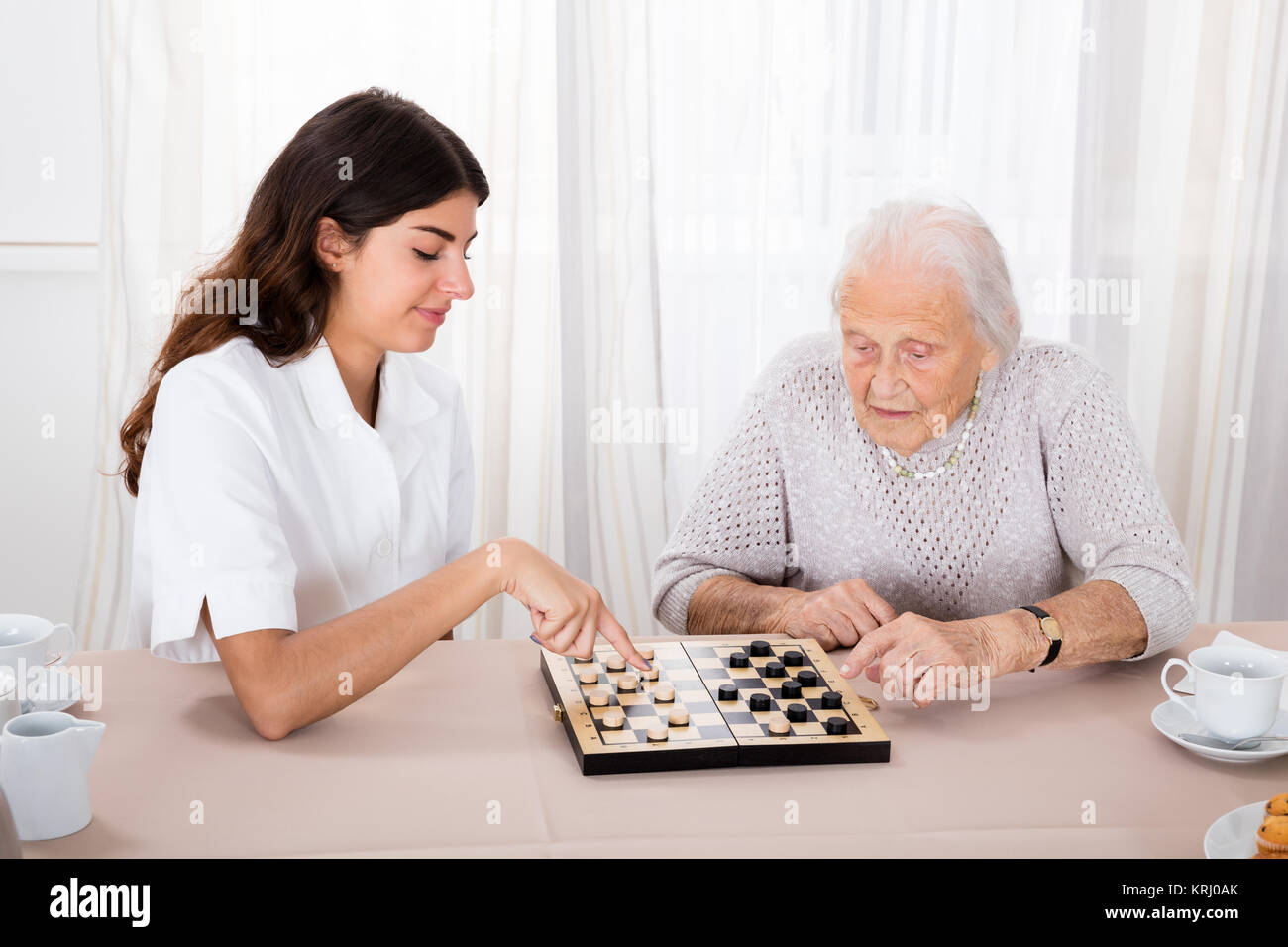 Two Women Playing Checkers Game Stock Photo - Alamy