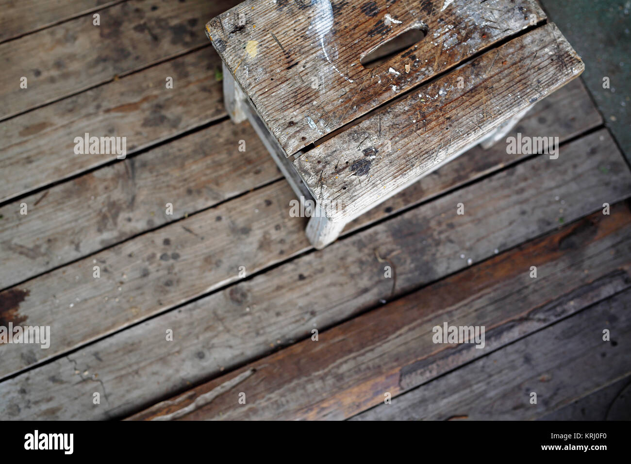 old wooden stool on a damaged wooden floor Stock Photo - Alamy