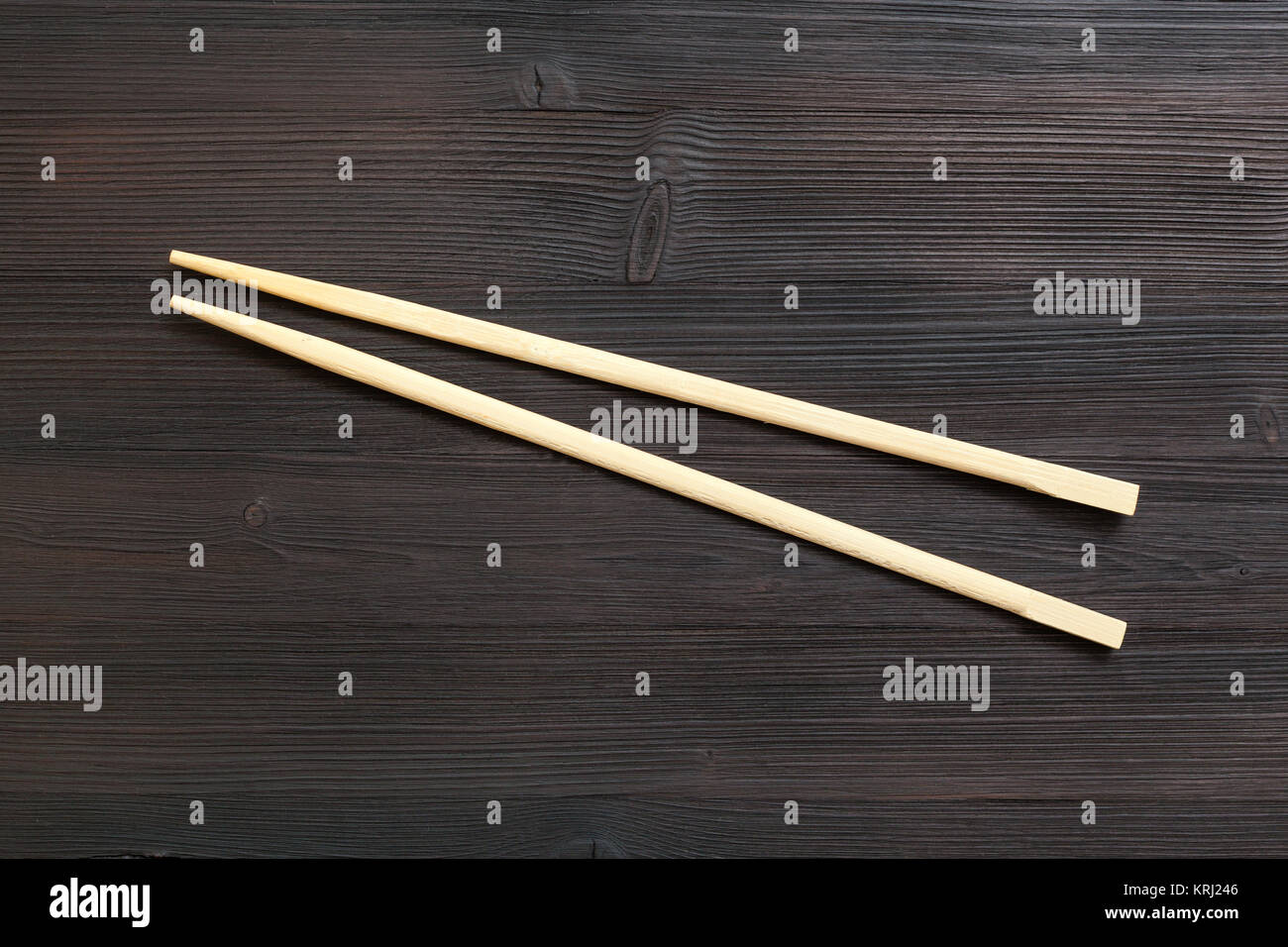 wooden disposable chopsticks on dark brown table Stock Photo - Alamy