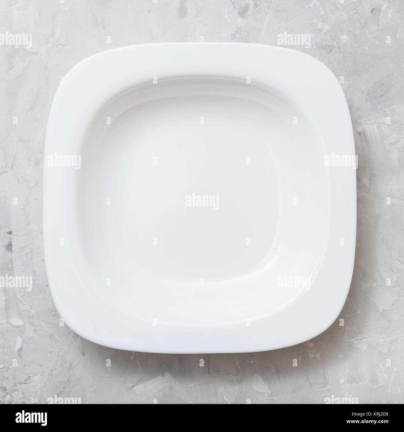 top view square white deep plate on concrete board Stock Photo - Alamy
