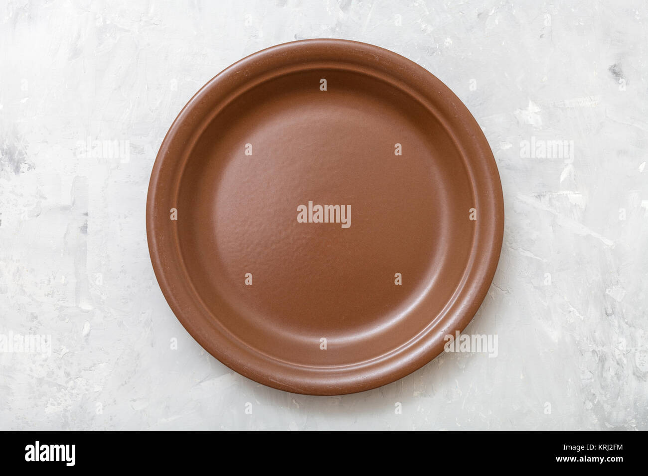 above view of one brown plate on gray concrete Stock Photo - Alamy