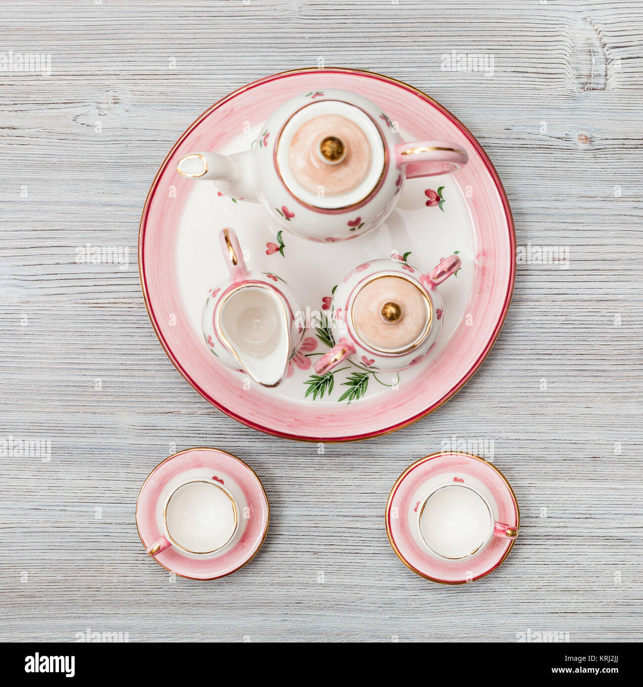 pink porcelain tea set on gray brown plank Stock Photo - Alamy