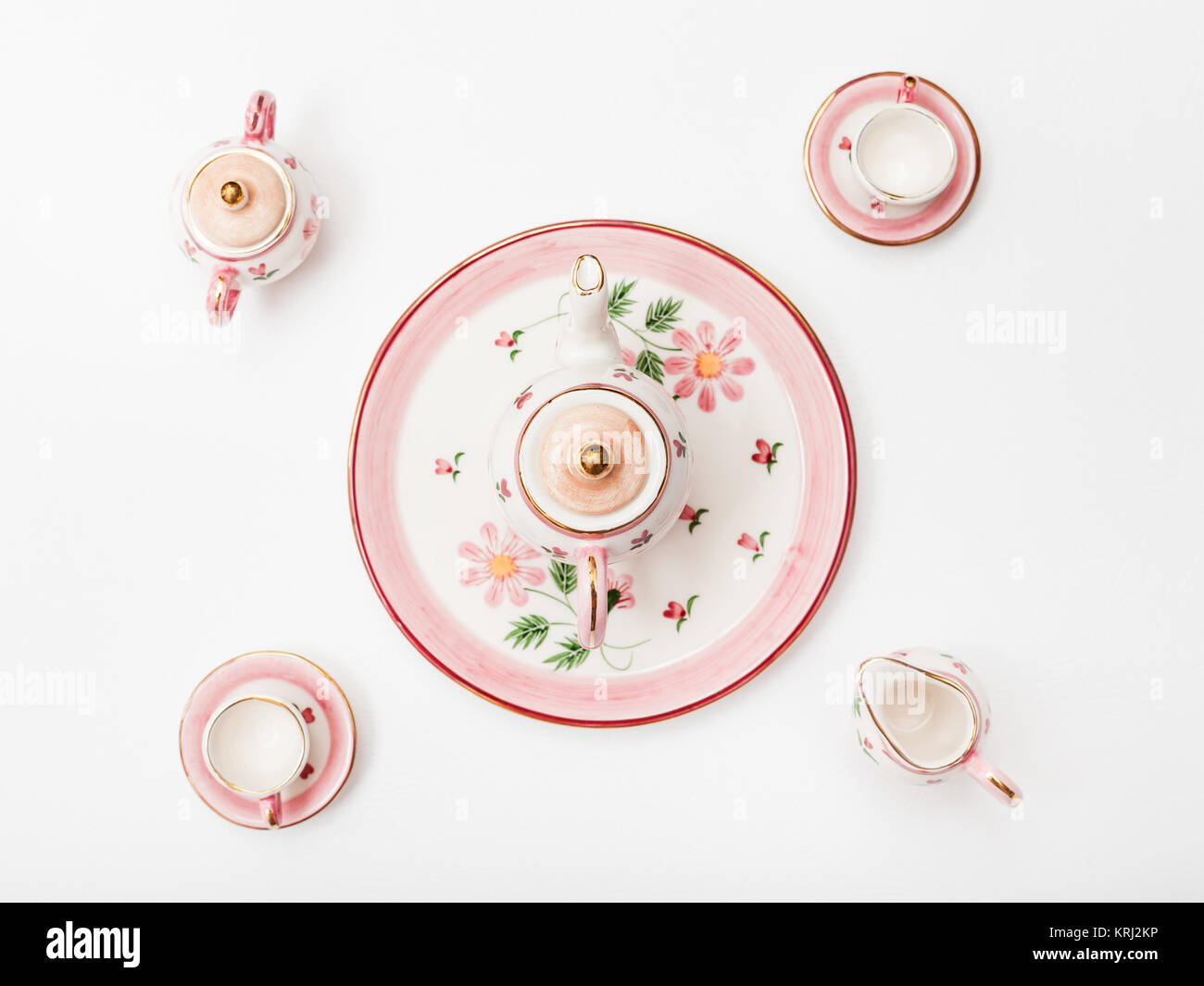 above view of pink porcelain tea set on white Stock Photo - Alamy