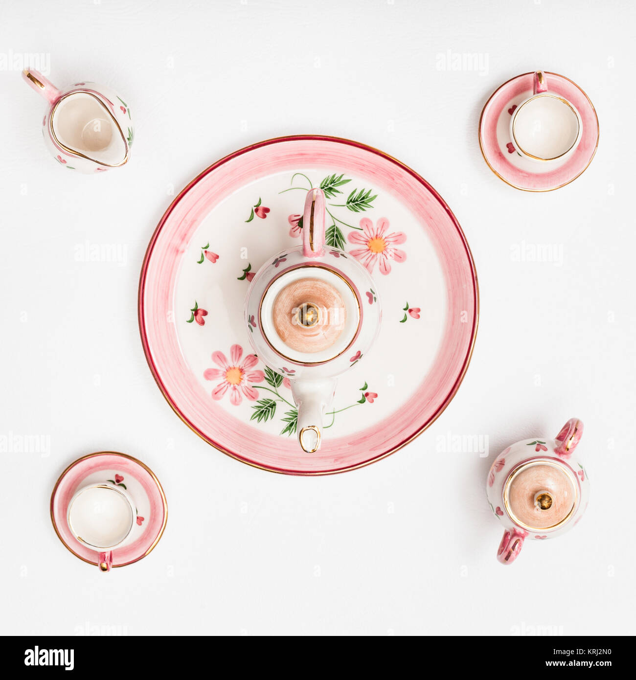 pink porcelain tea set on white paper background Stock Photo - Alamy