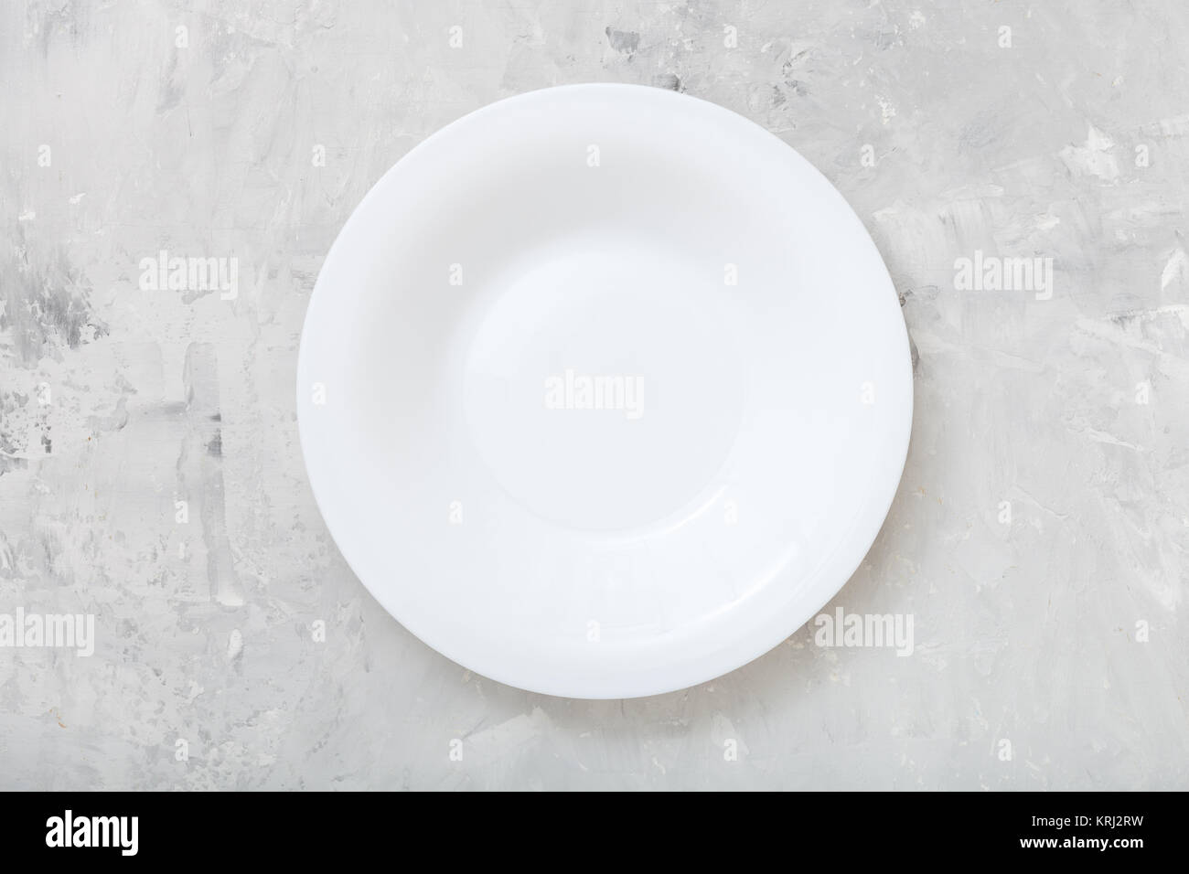 top view of white deep plate on concrete board Stock Photo - Alamy