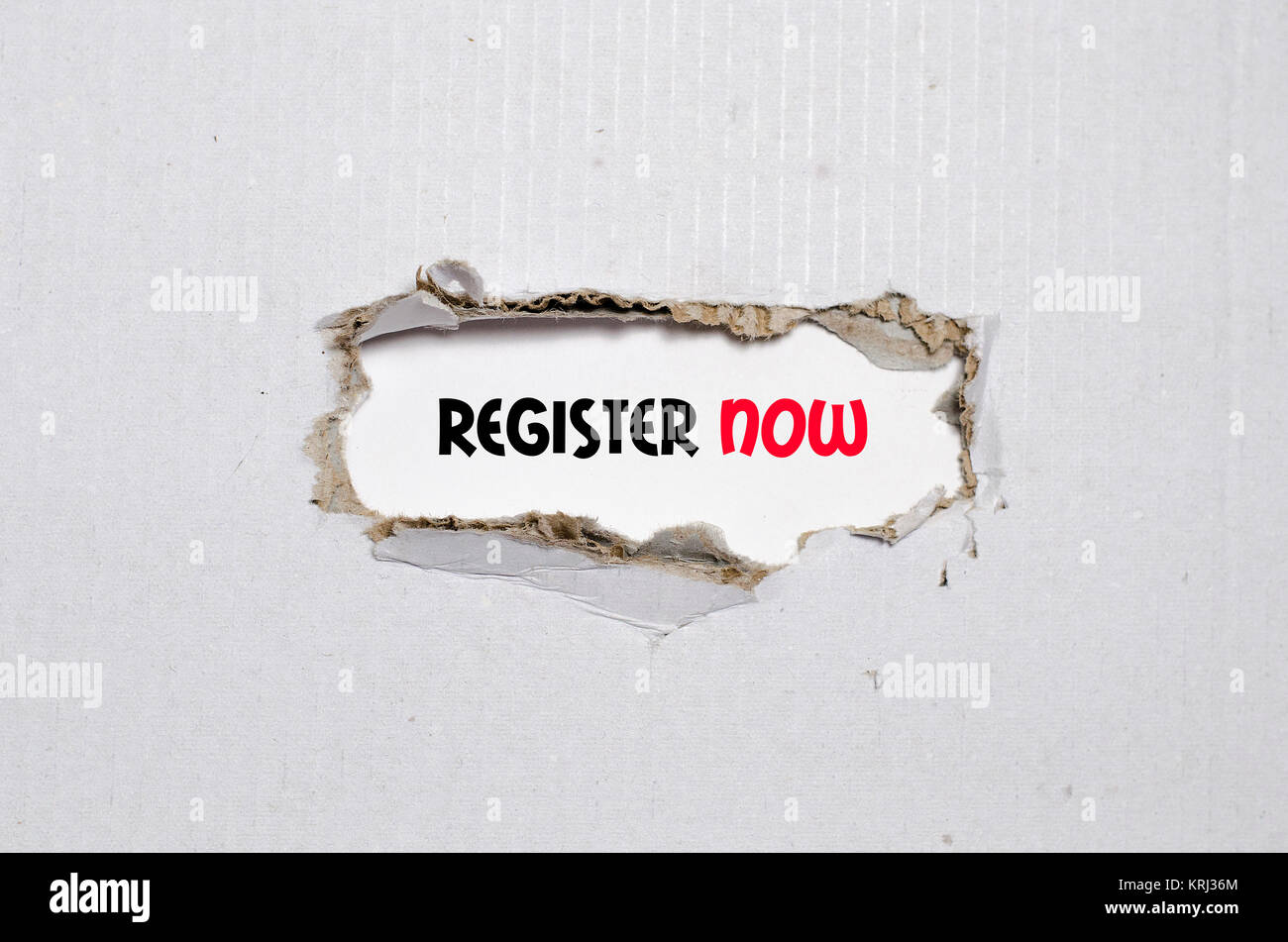 The word register now appearing behind torn paper Stock Photo - Alamy