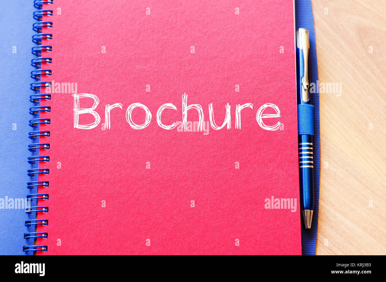 Brochure text concept on notebook Stock Photo - Alamy