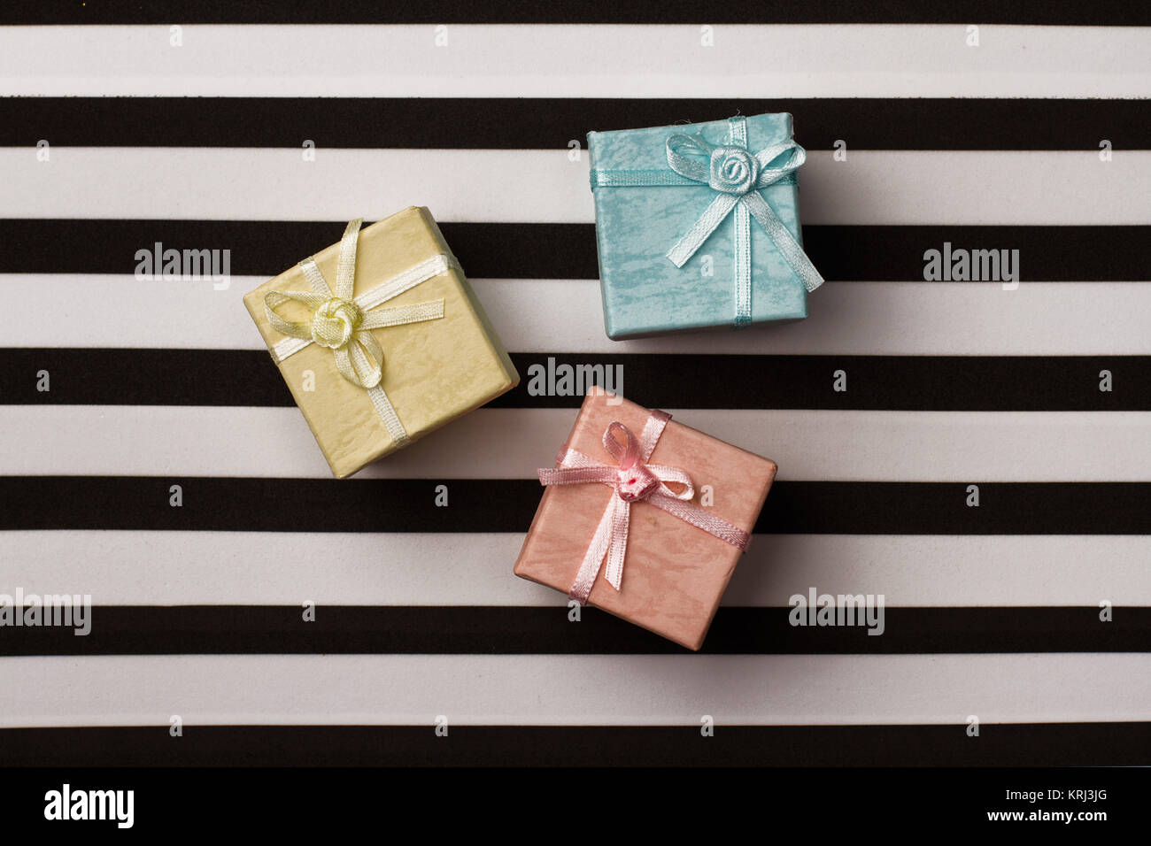 small gift boxes on stripes paper background Stock Photo - Alamy