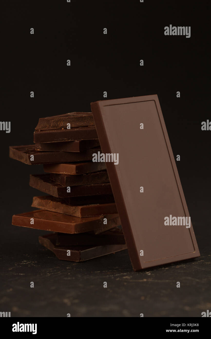 Square shaped chocolate pieces on dark background Stock Photo - Alamy