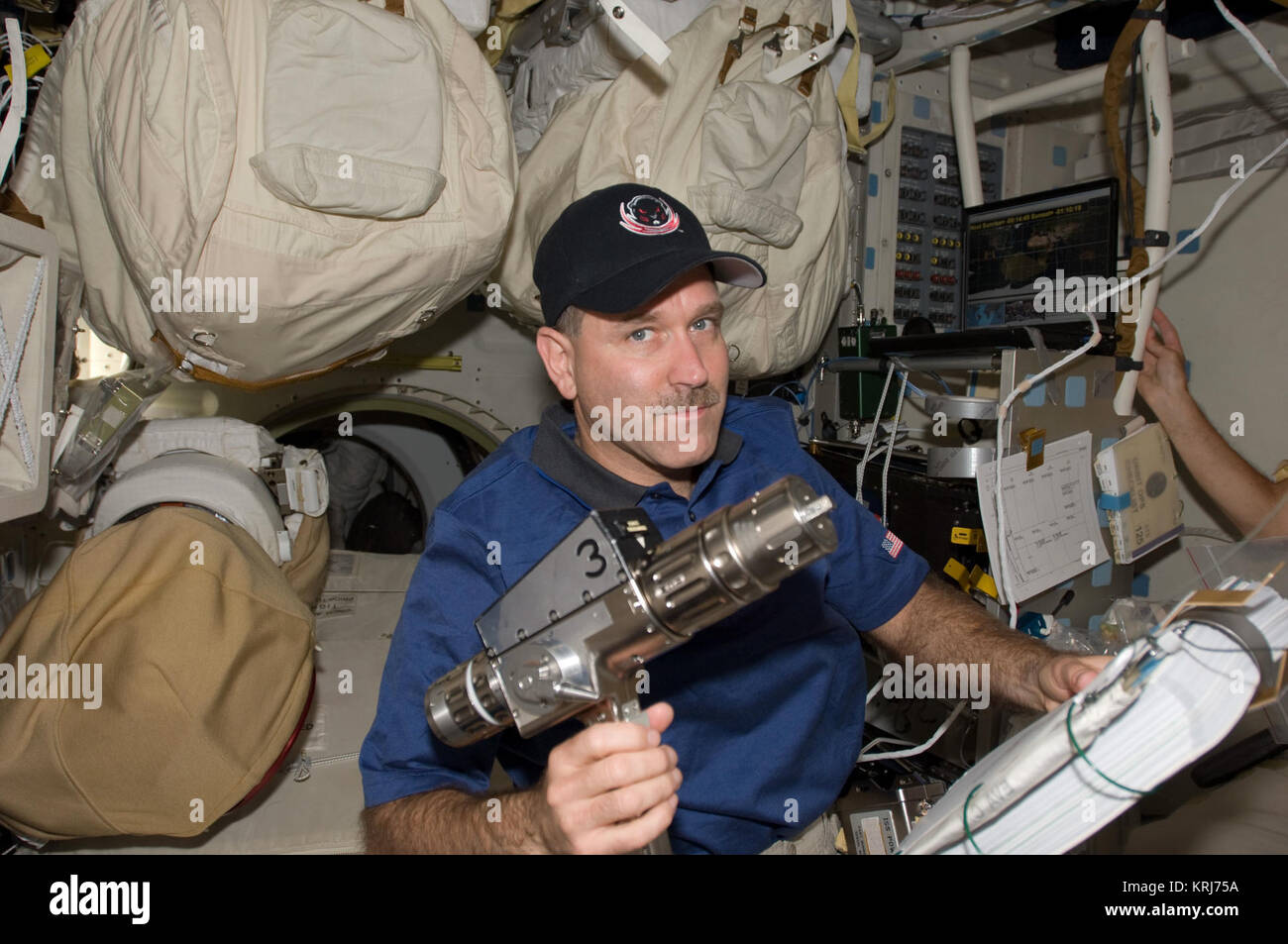 STS-125 Grunsfeld prepares a power tool Stock Photo - Alamy