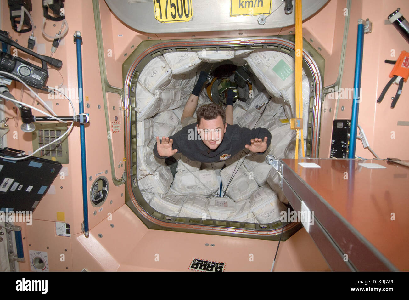 ISS-20 Roman Romanenko floats through a hatch into the Unity node Stock ...